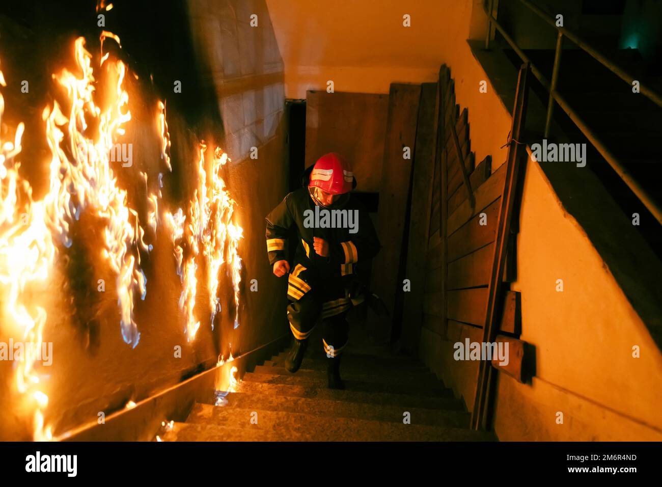 Brave Fireman Descends Stairs of a Burning Building and Holds Saved ...