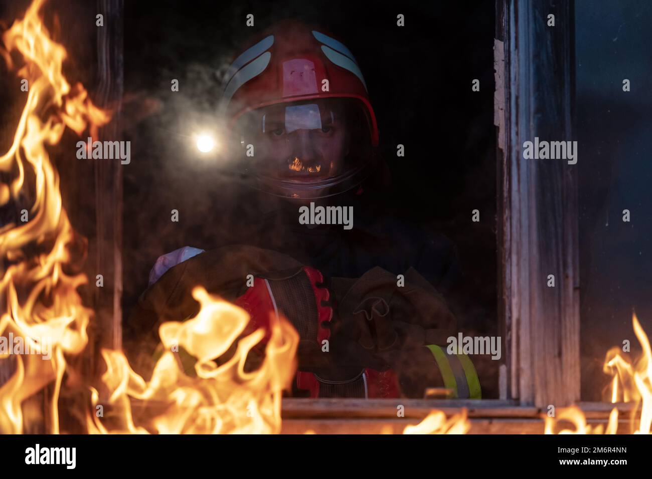 Firefighter hero carrying baby girl out from burning building area from ...