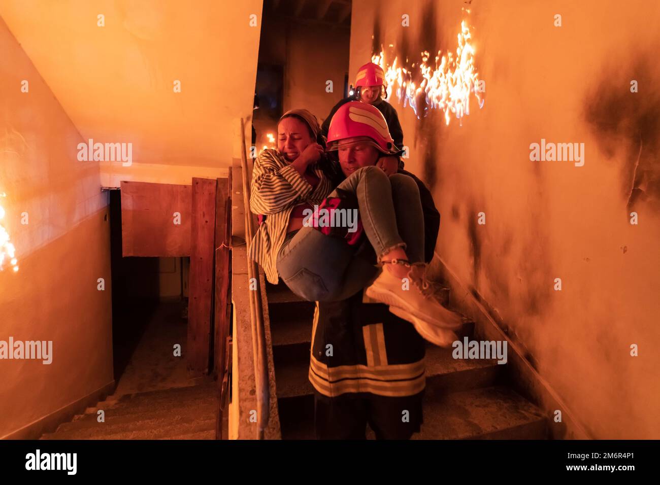 Brave Fireman Descends Stairs of a Burning Building and Holds Saved ...