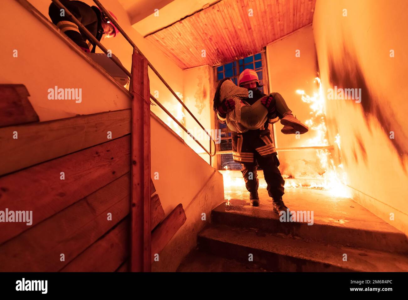 Brave Fireman Descends Stairs of a Burning Building and Holds Saved ...