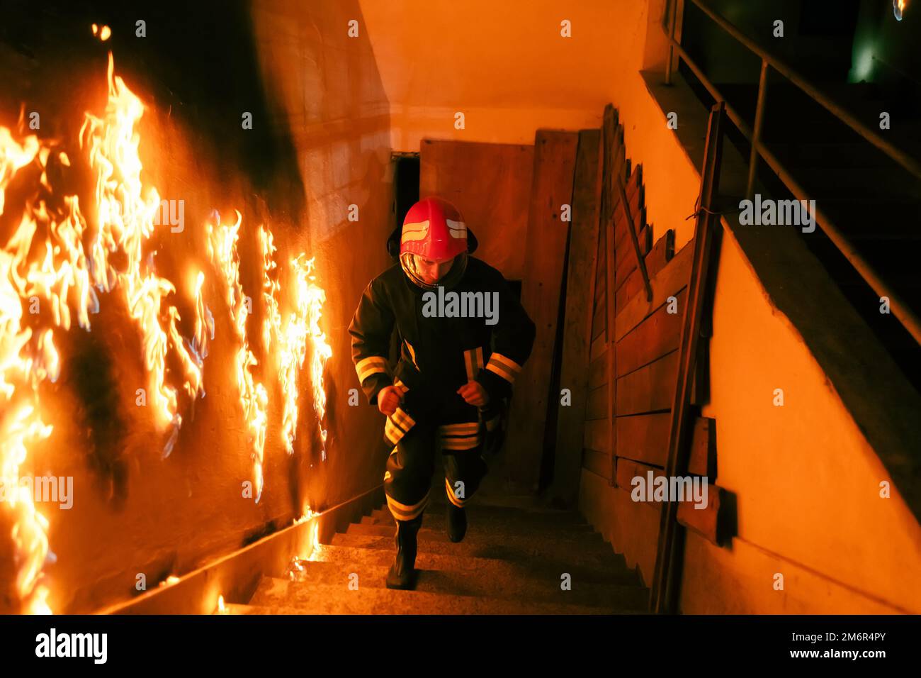Brave Fireman going upstairs to save and rescue people in a Burning ...