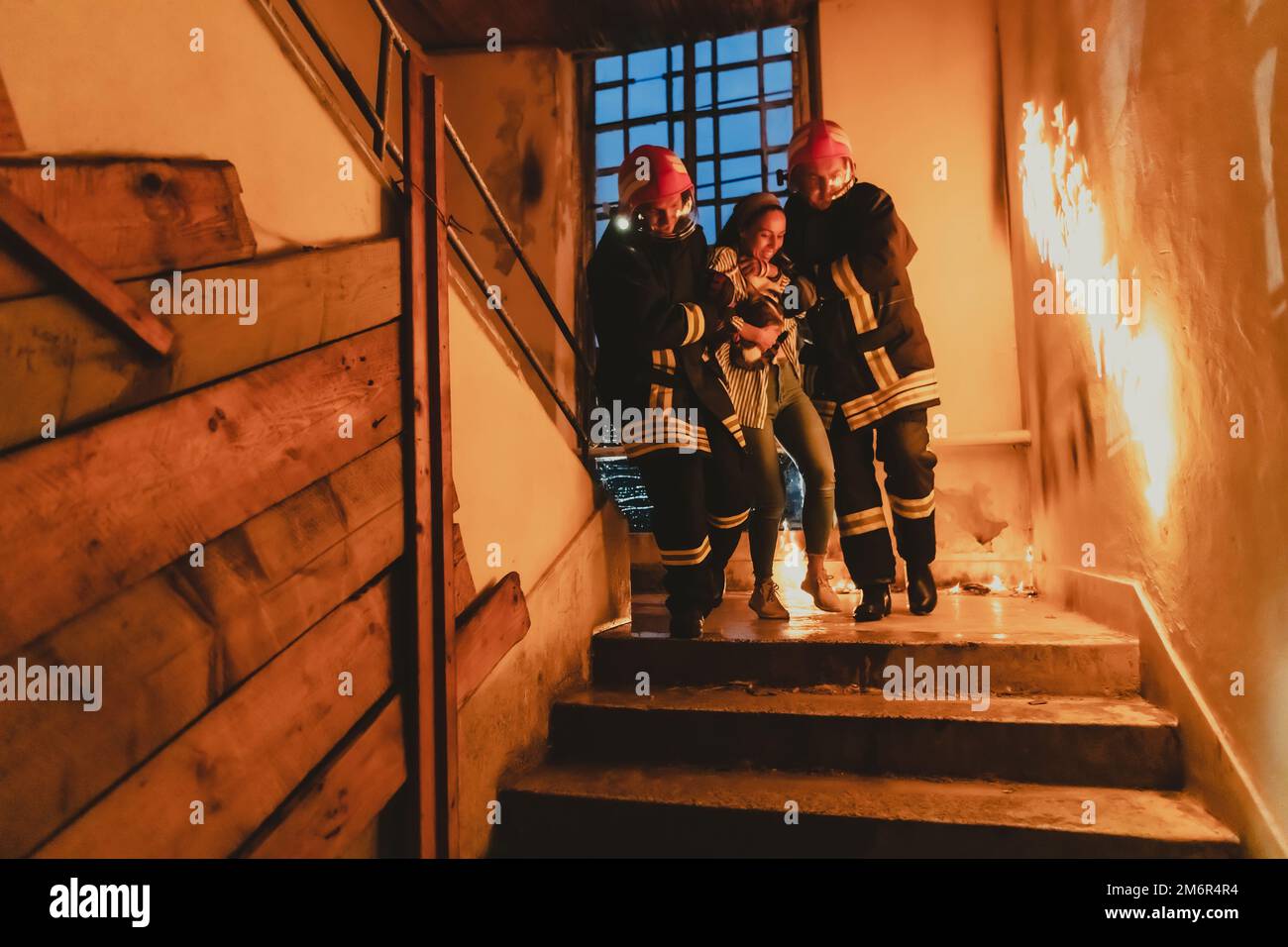 Brave Fireman Descends Stairs of a Burning Building and Holds Saved ...