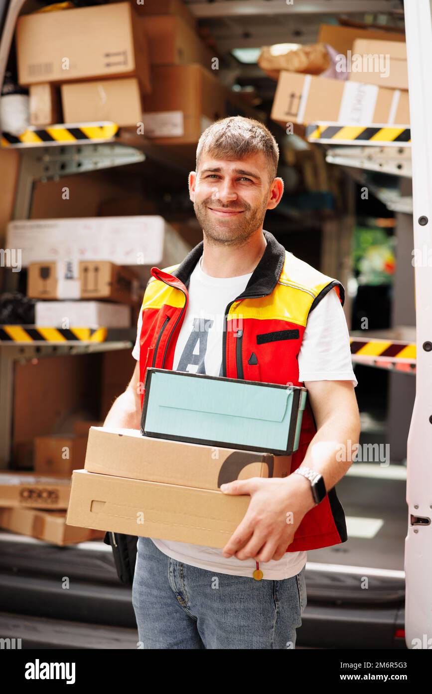 A man who smiles and is ready to deliver. In the background, you can ...