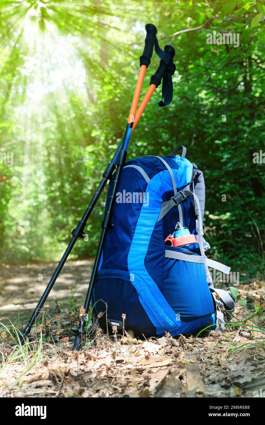 Backpack and trekking poles Stock Photo - Alamy