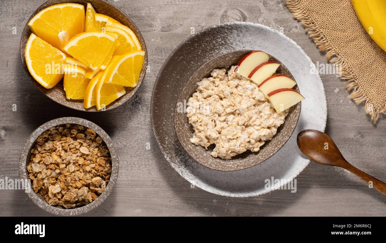 Oatmeal porridge with fruits for healthy breakfast. Table top view ...