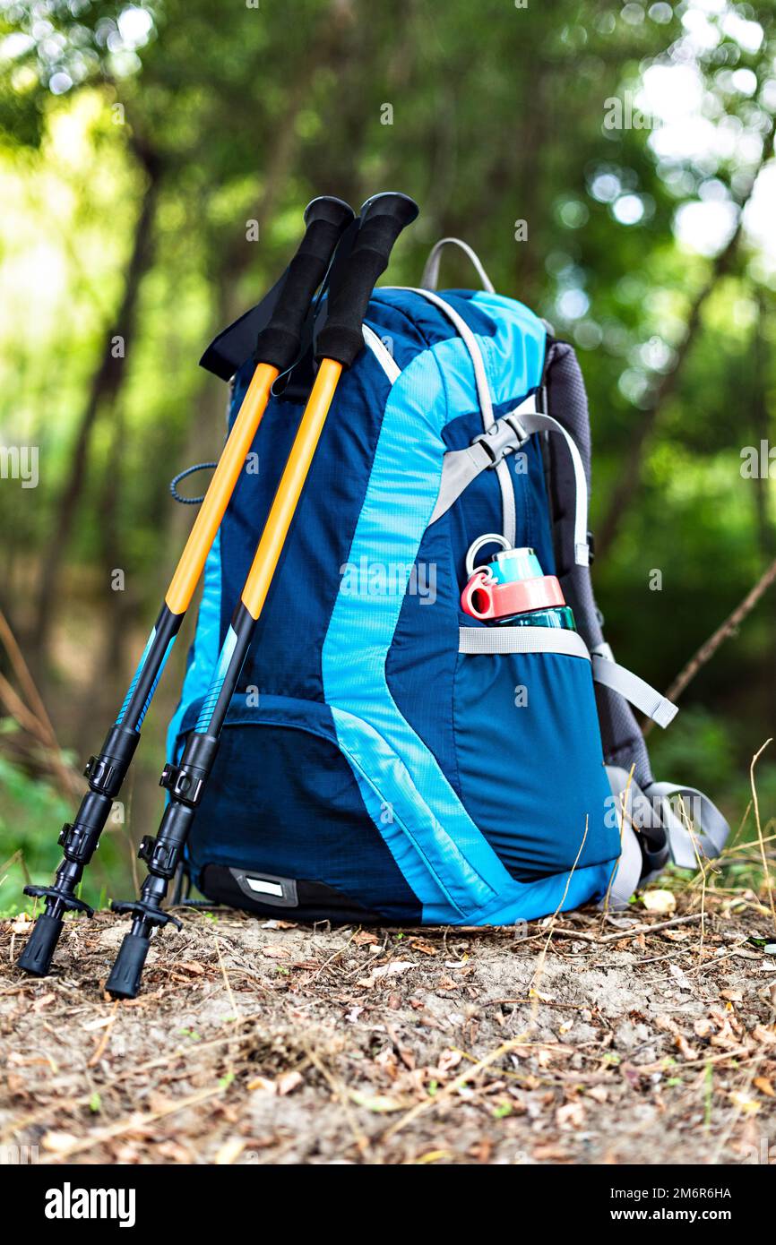 Backpack and trekking poles Stock Photo - Alamy