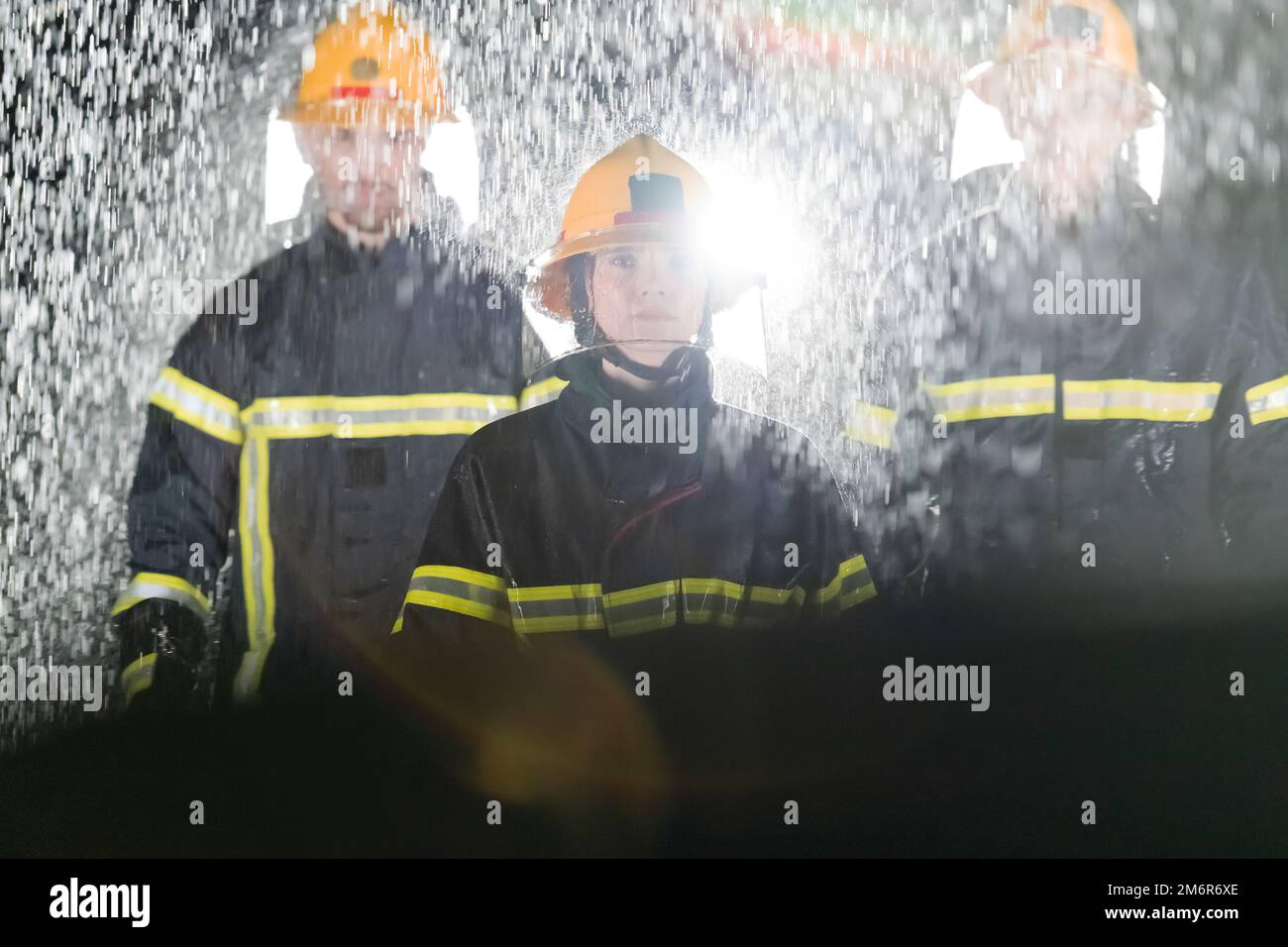 Portrait of a group of firefighters standing and walking brave and ...