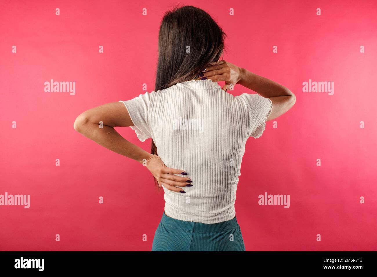 Young beautiful woman wearing ribbed crop isolated over red background ...