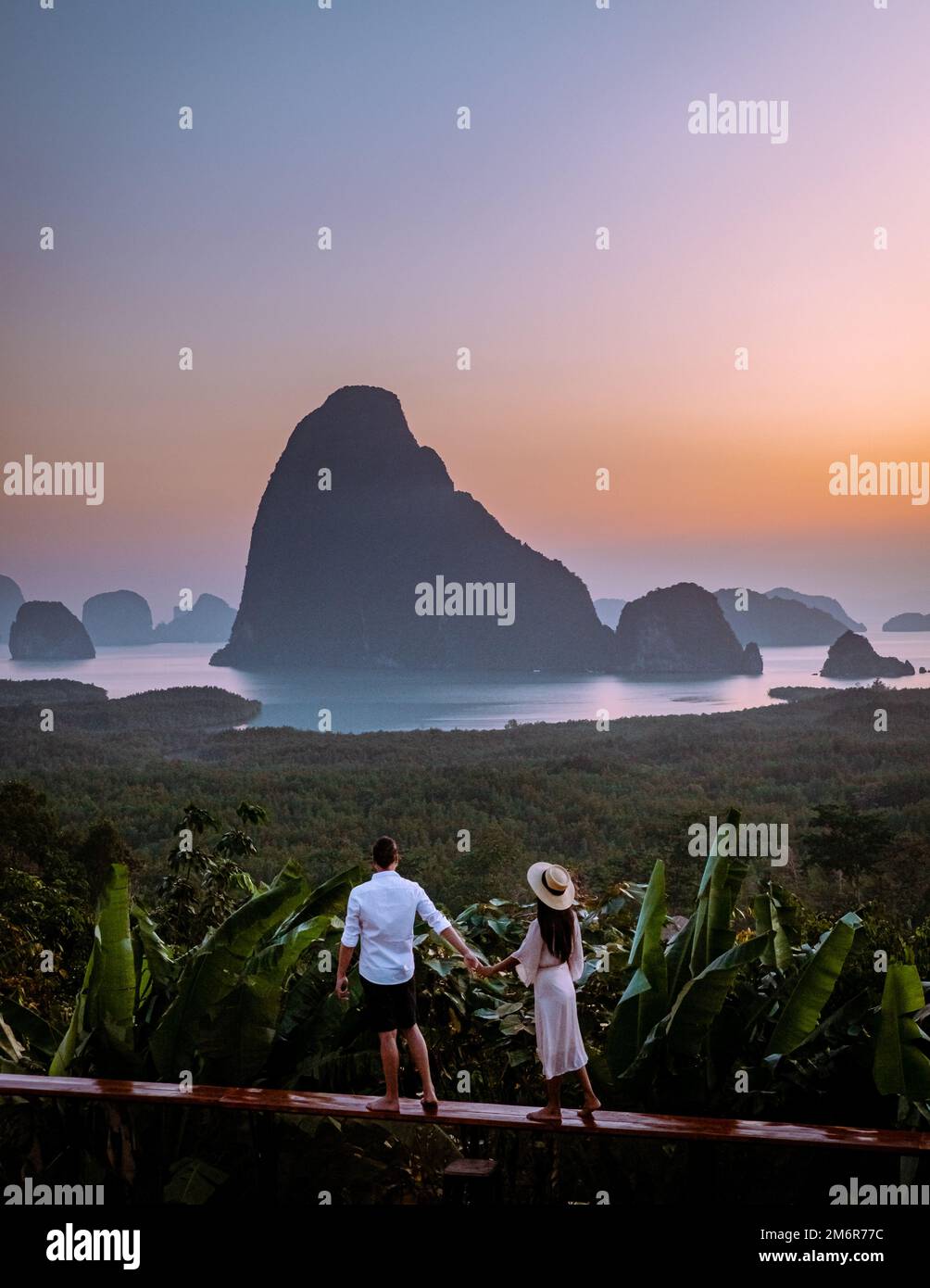 Young men and women on vacation in Thailand Phannga watching the ...