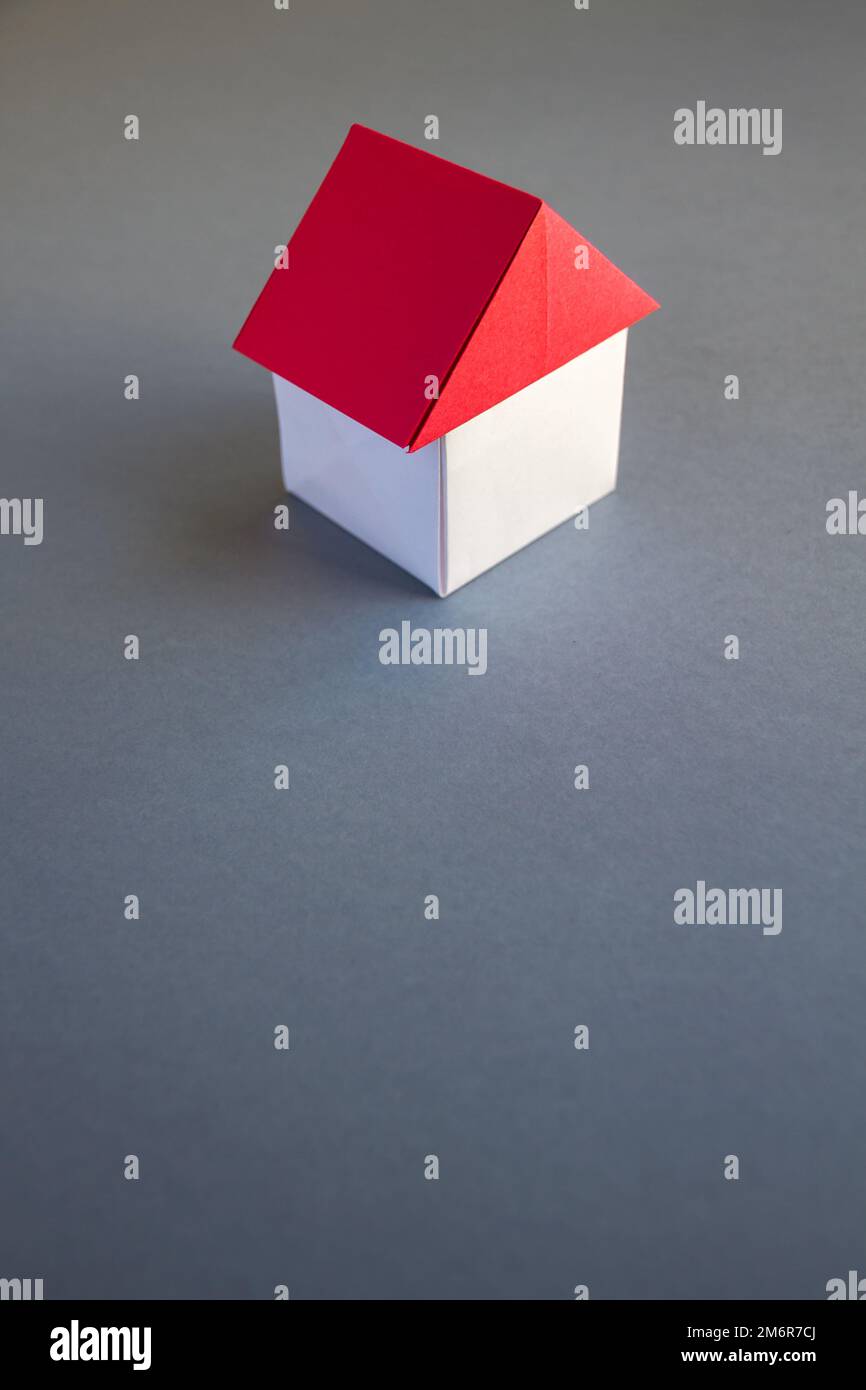 White and red paper house origami isolated on grey background Stock ...