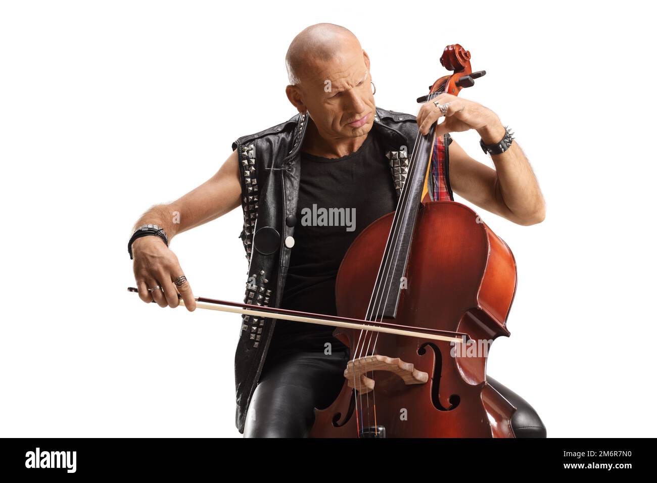 Bald musician in a leather vest playing a cello isolated on white ...