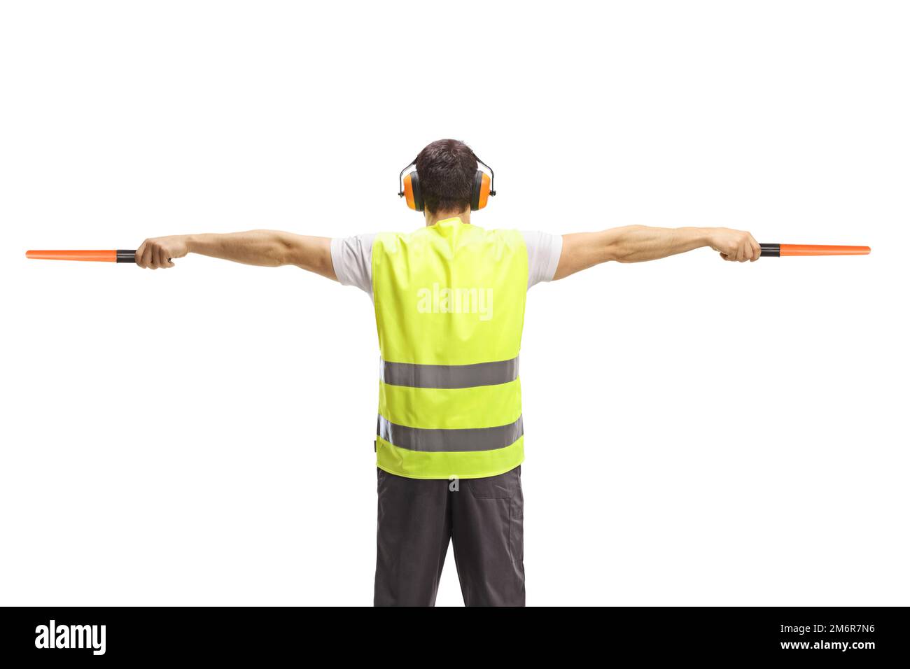 Back view of an aircraft marshaller signalling with wands isolated on ...