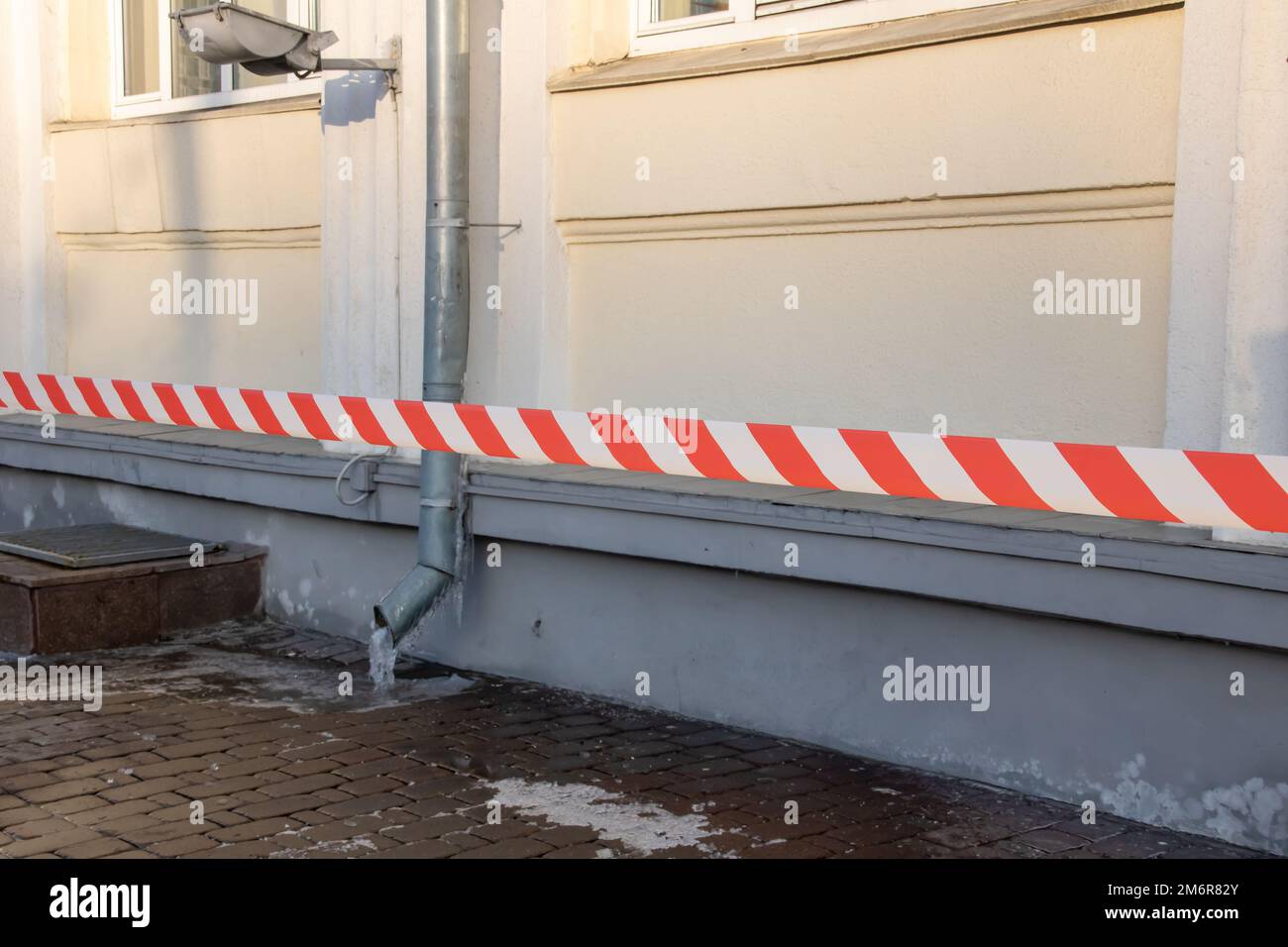 Warning red and white tape against the wall close up Stock Photo - Alamy