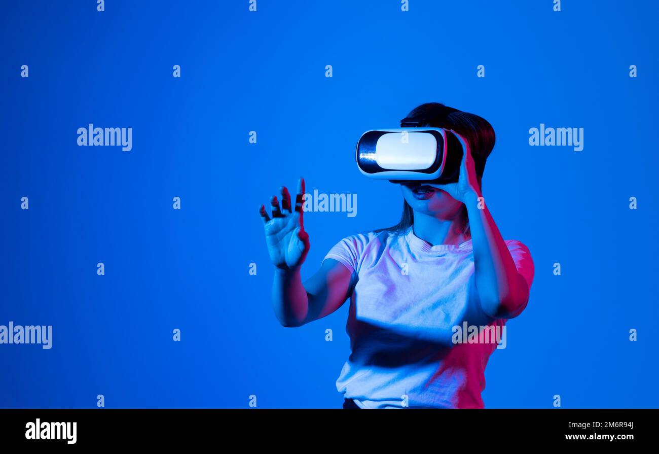 Woman in white shirt wearing VR glassess, VR set equipment for ...