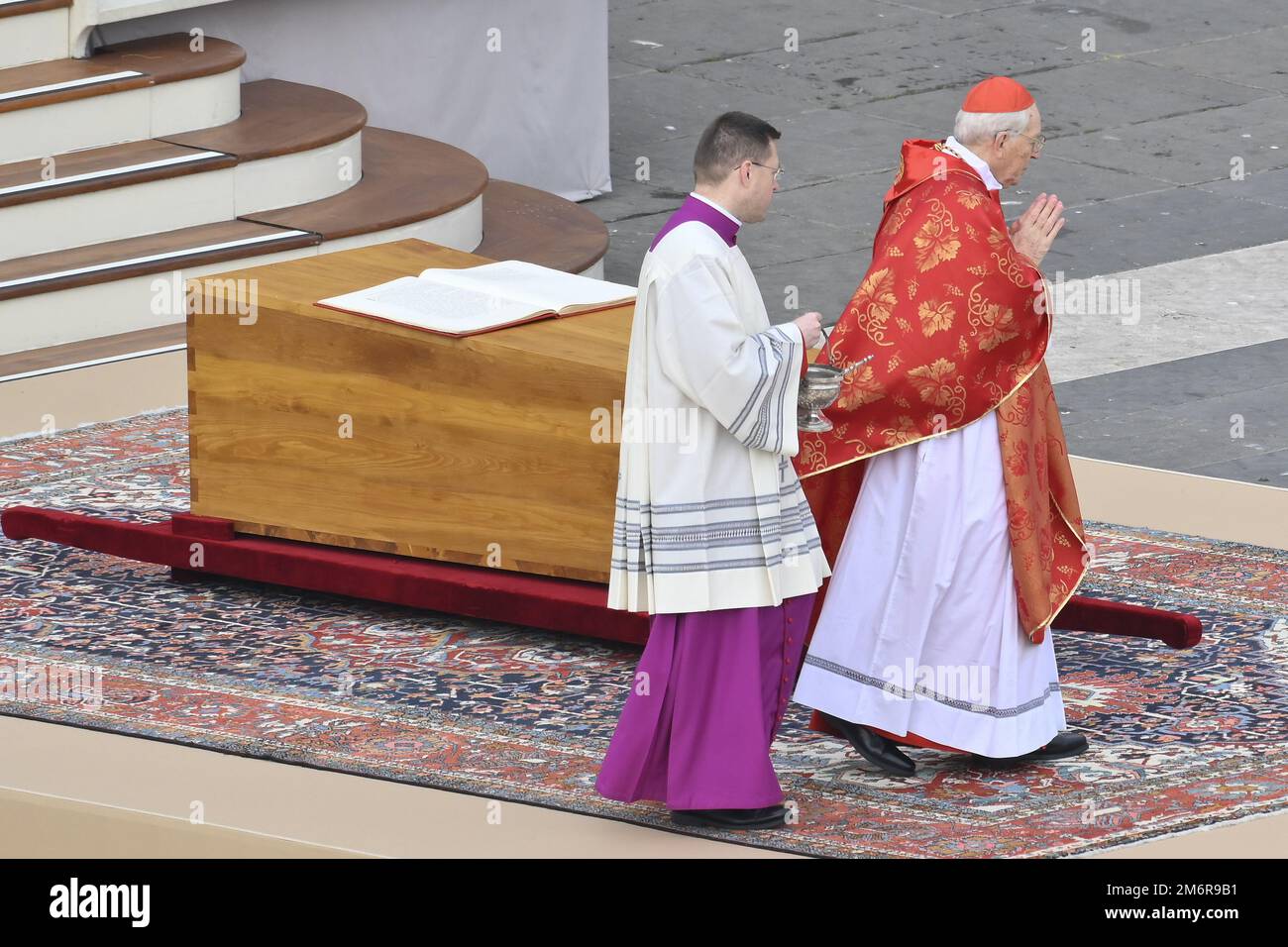 Cardinal Giovanni Battista Re blesses the coffin of Pope Emeritus ...