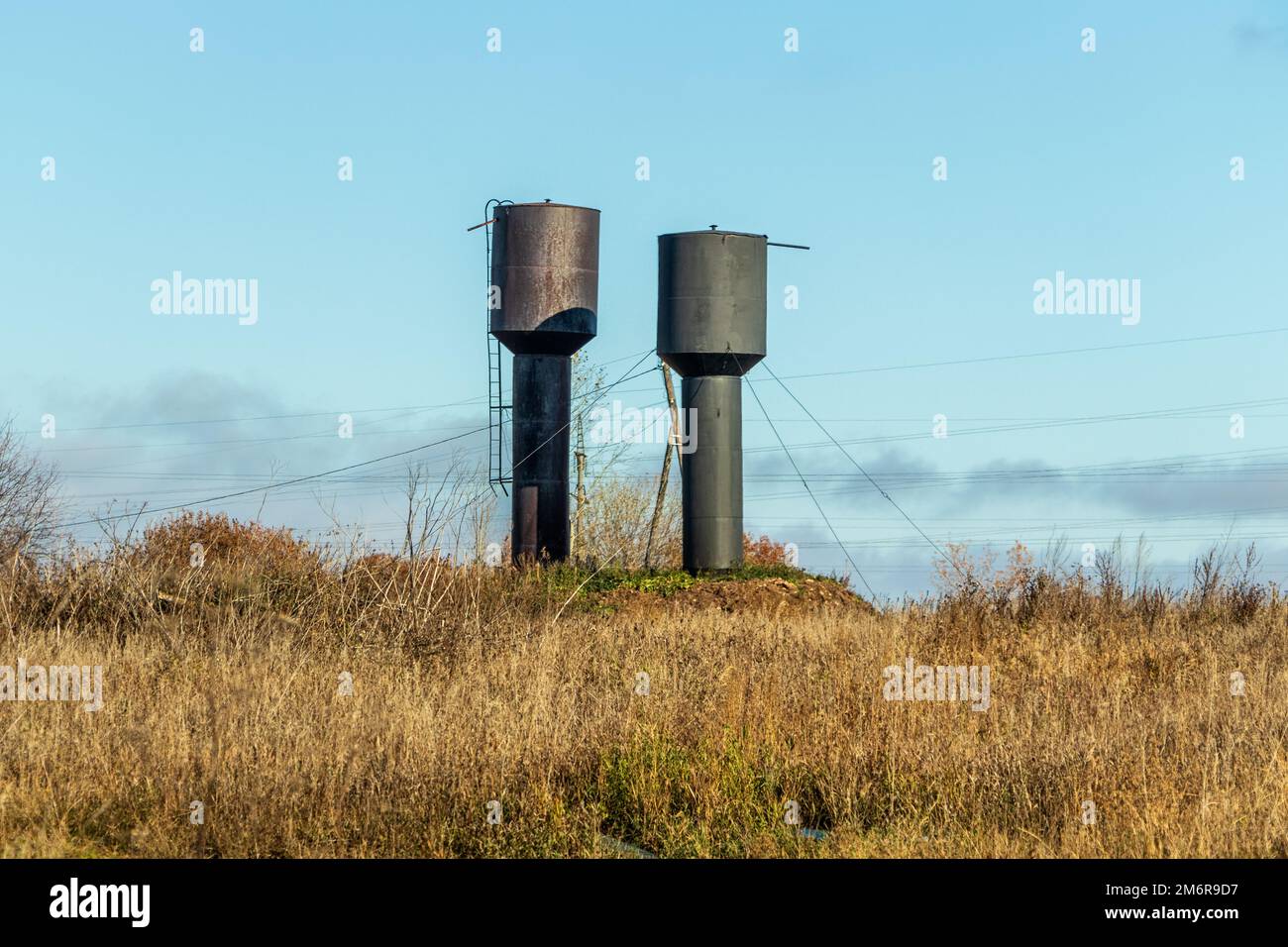 Two water towers stand in the field. Photo taken in the village of ...