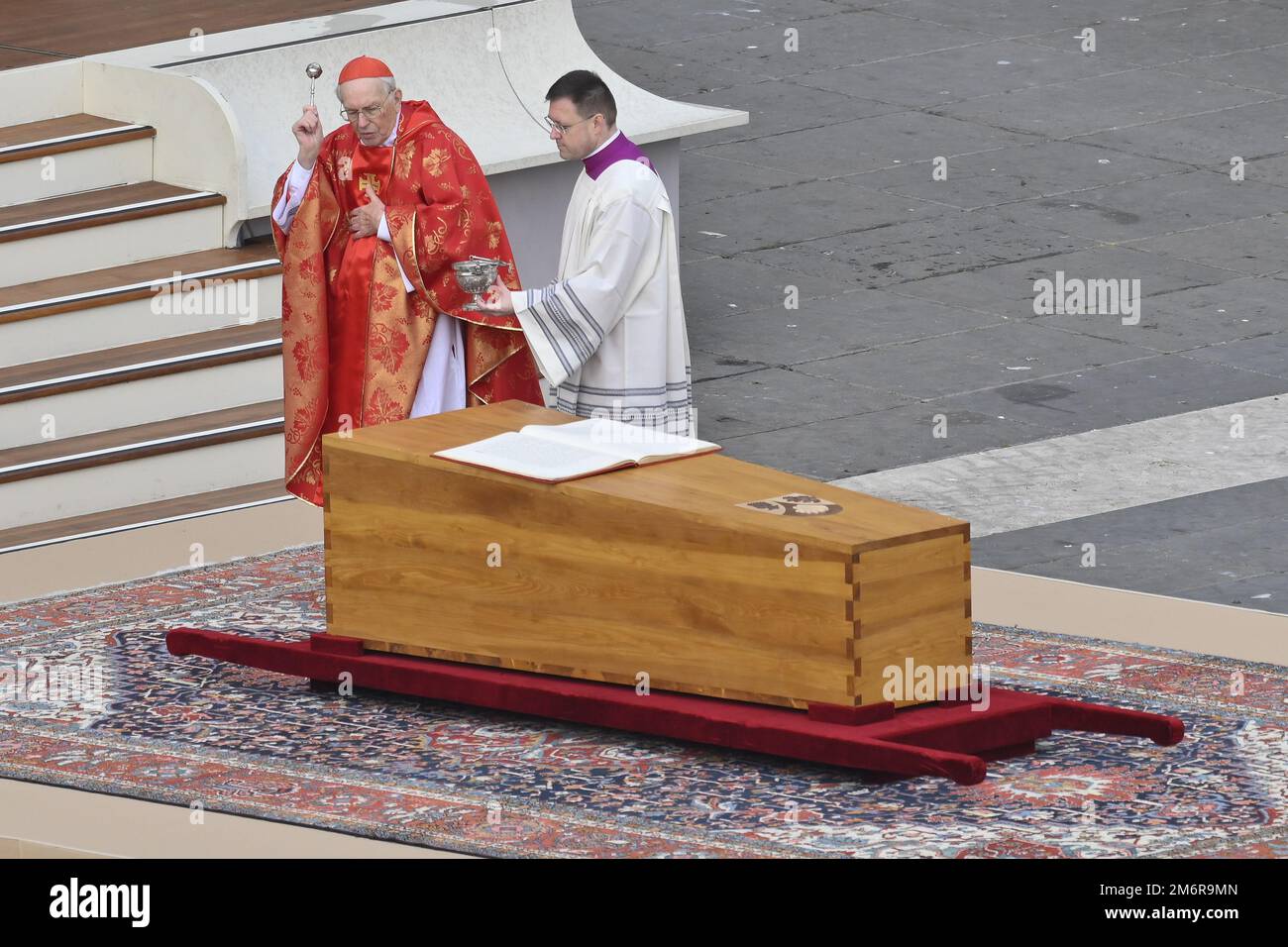 Cardinal Giovanni Battista Re blesses the coffin of Pope Emeritus ...