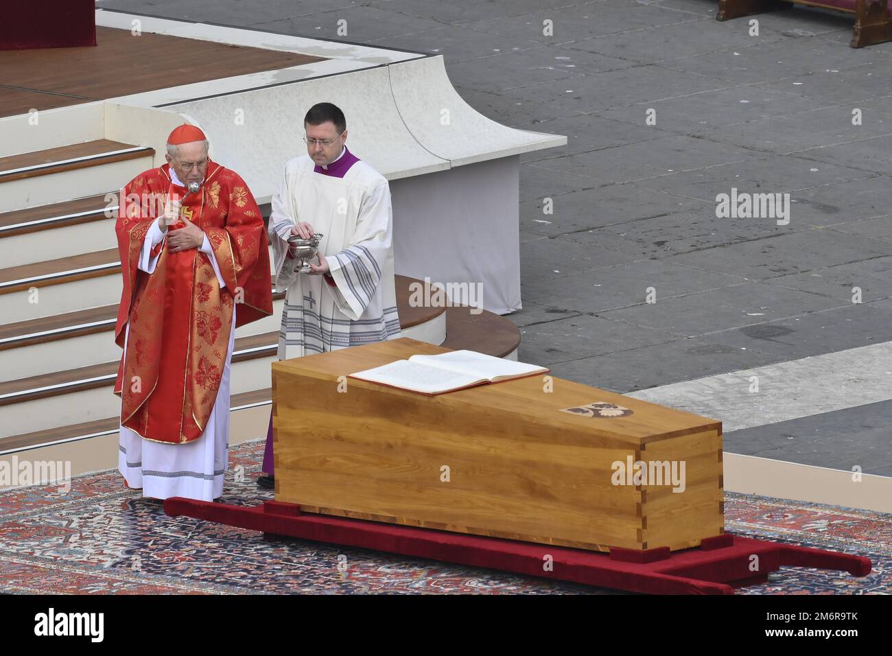 Cardinal Giovanni Battista Re blesses the coffin of Pope Emeritus ...
