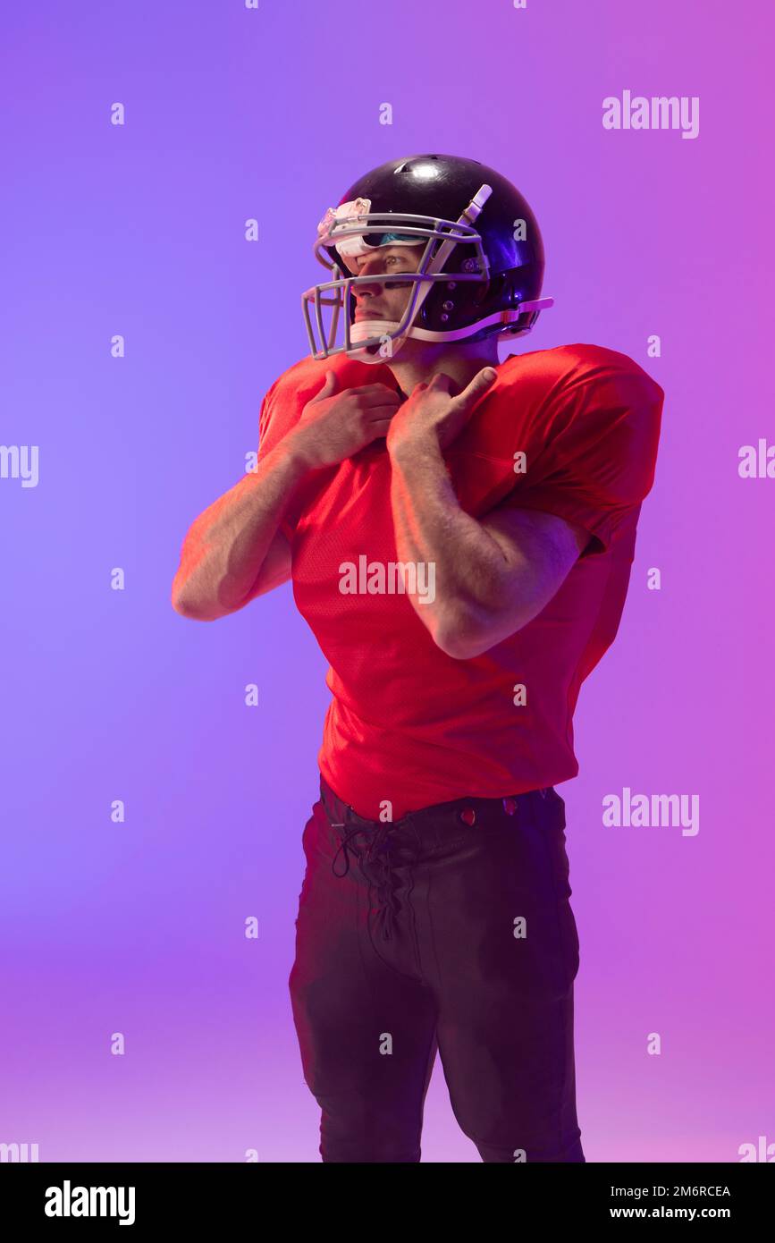 Caucasian male american football player wearing helmet with neon blue ...