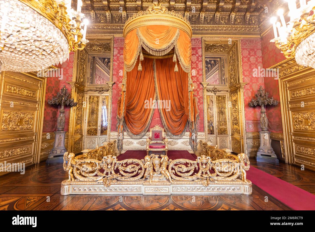 Old throne room interior with chair in luxury palace. Red and gold ...