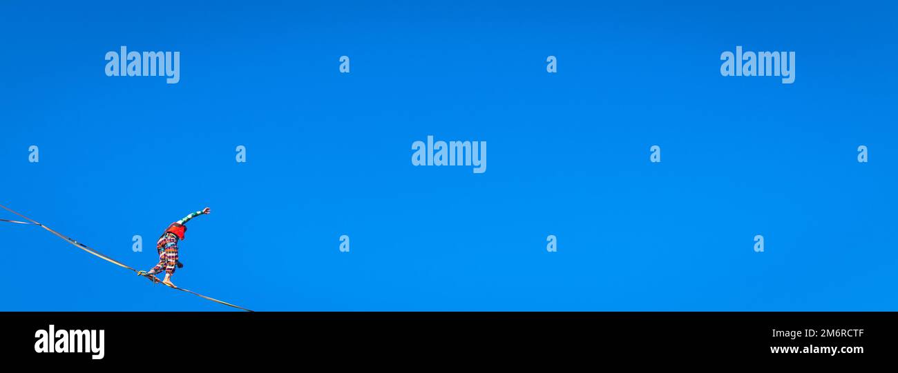 Slackline athlete during his performance. Concentration, balance and ...