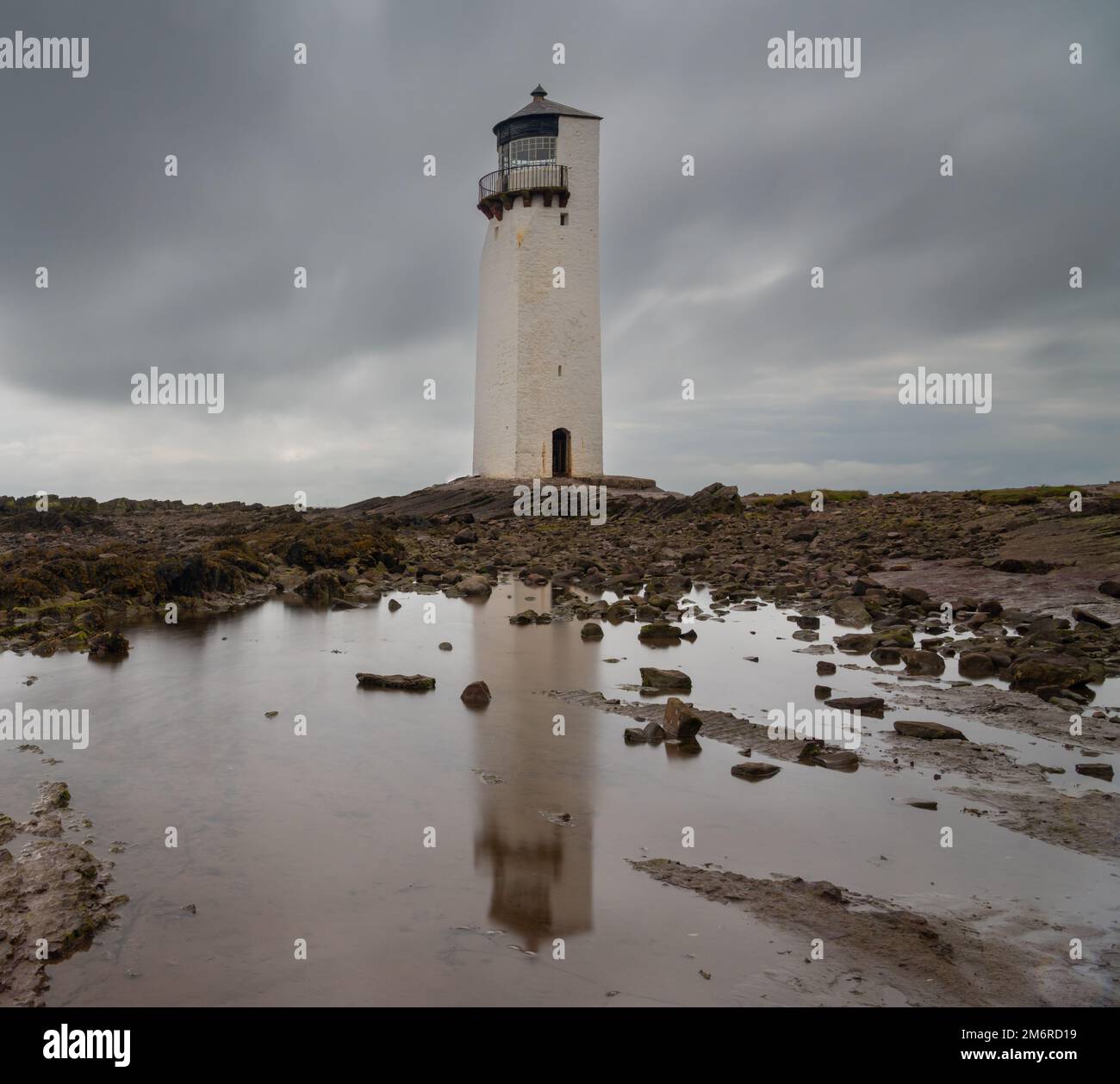 The historic Southerness Lighthouse in Scotland with reflections in ...