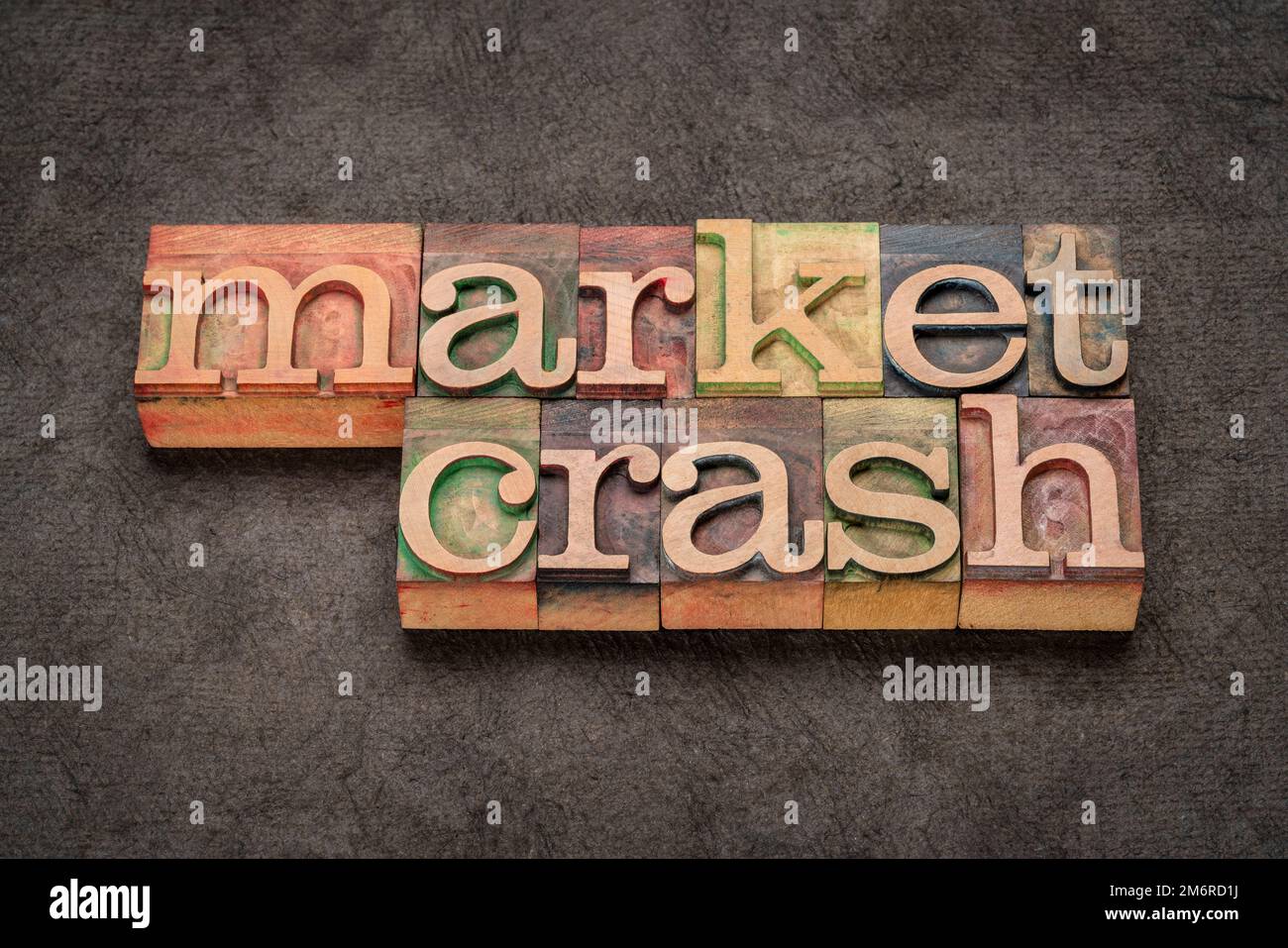 market crash word abstract in letterpress wood type against black ...