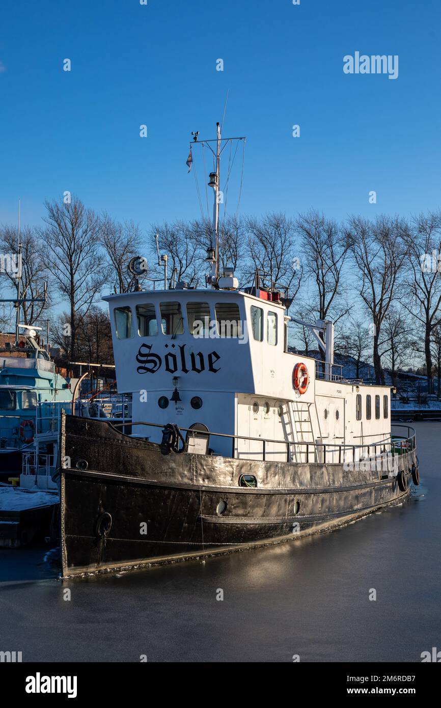 Moored M/S Sölve surrounded by ice in Sörnäisten ranta, Helsinki ...