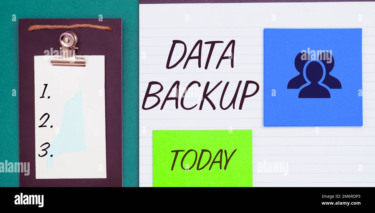 Hand writing sign Data Backup. Concept meaning copy of important data that is stored on an ...