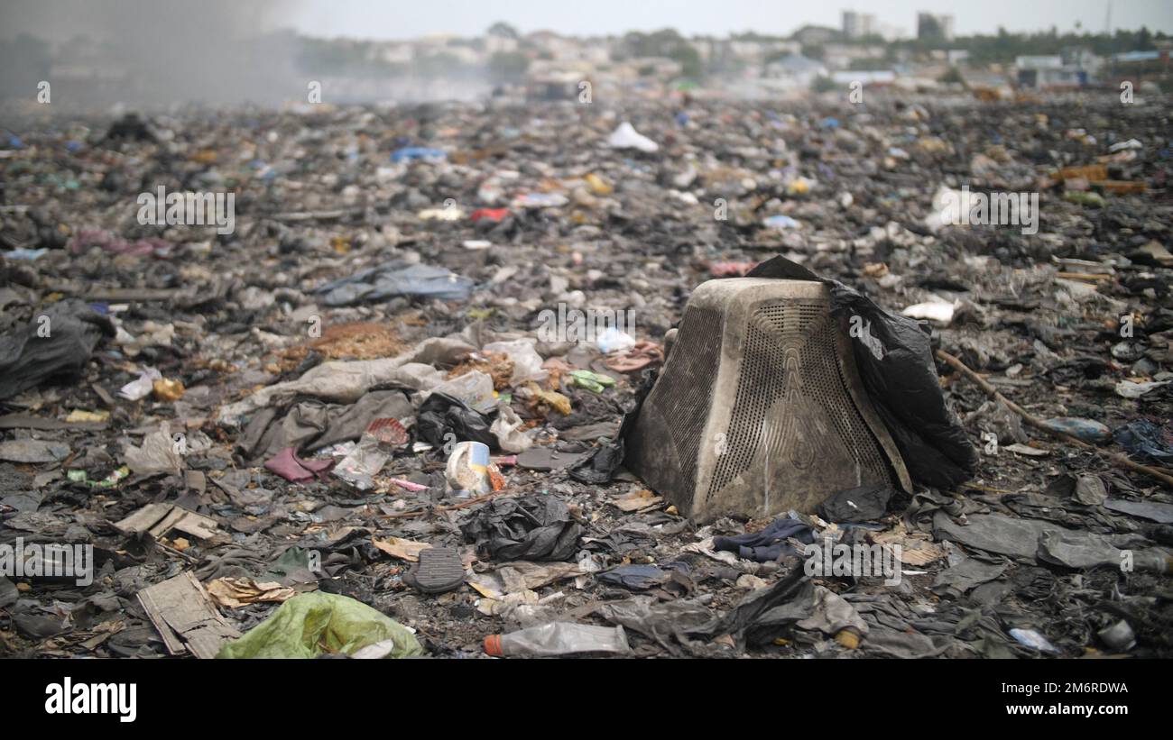 A closeup shot of abandoned trash on a polluted sea shore in Accra ...