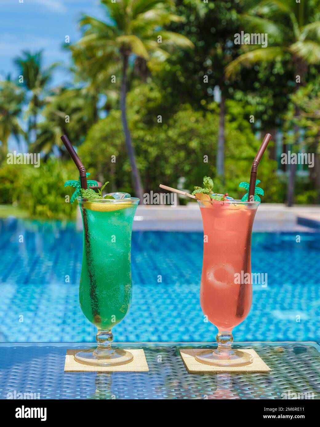 Colorful mocktail at a pool bar, orange and green cocktail by the pool ...