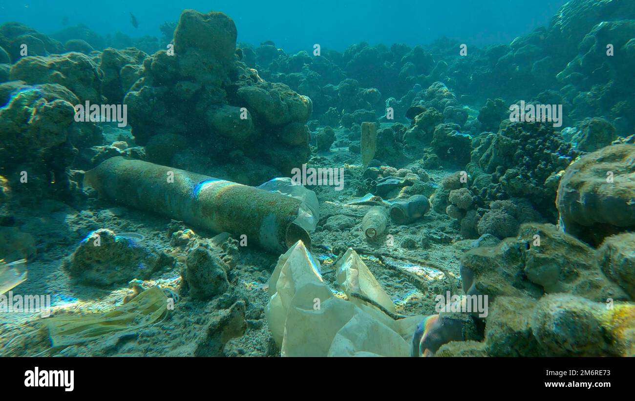 Seabed of beautiful coral reef covered with plastic and other garbage ...