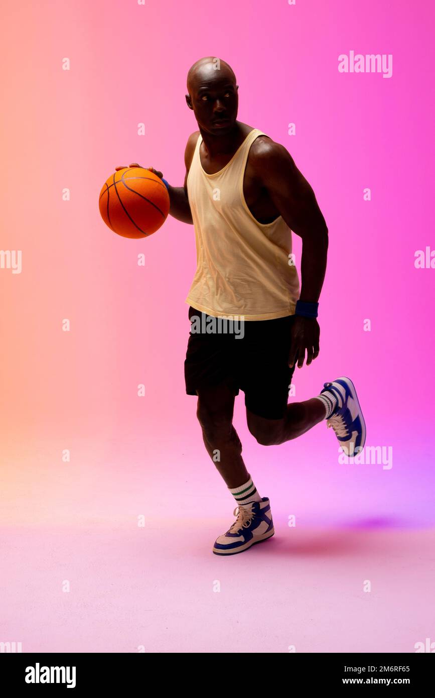 Image of african american basketball player with basketball on neon ...