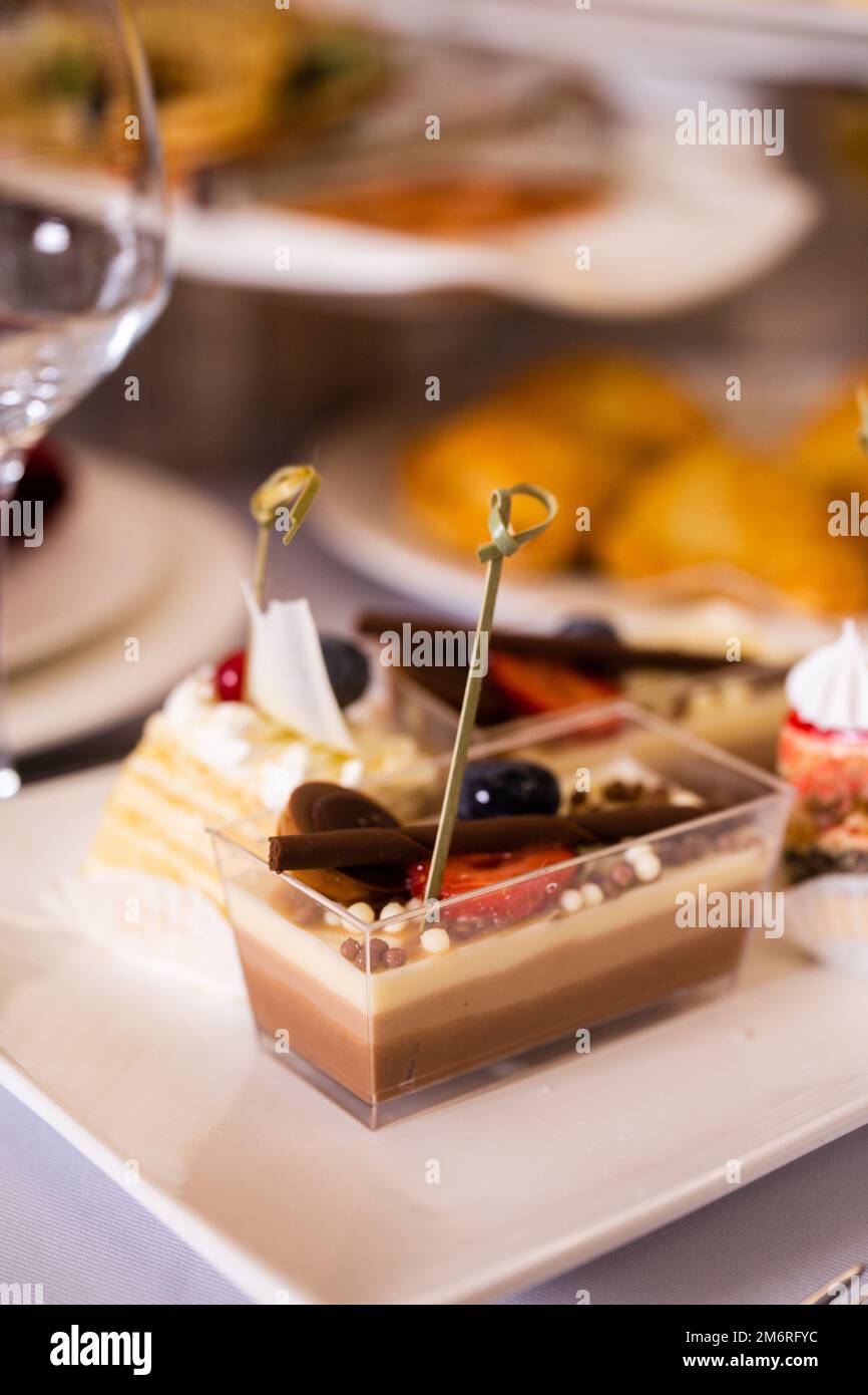 dessert layers in plastic dishes close-up on the buffet table Stock ...