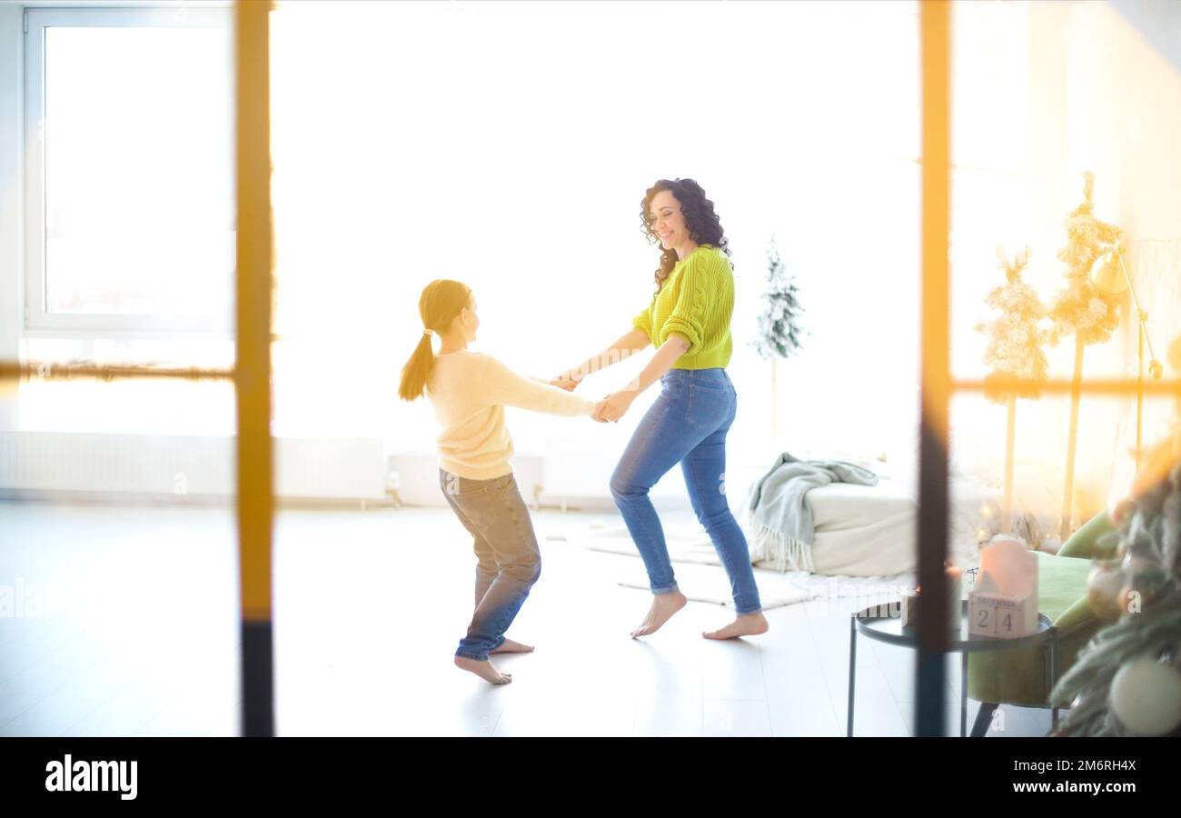 Happy family at home. Little girl daughter dancing with smiling ...