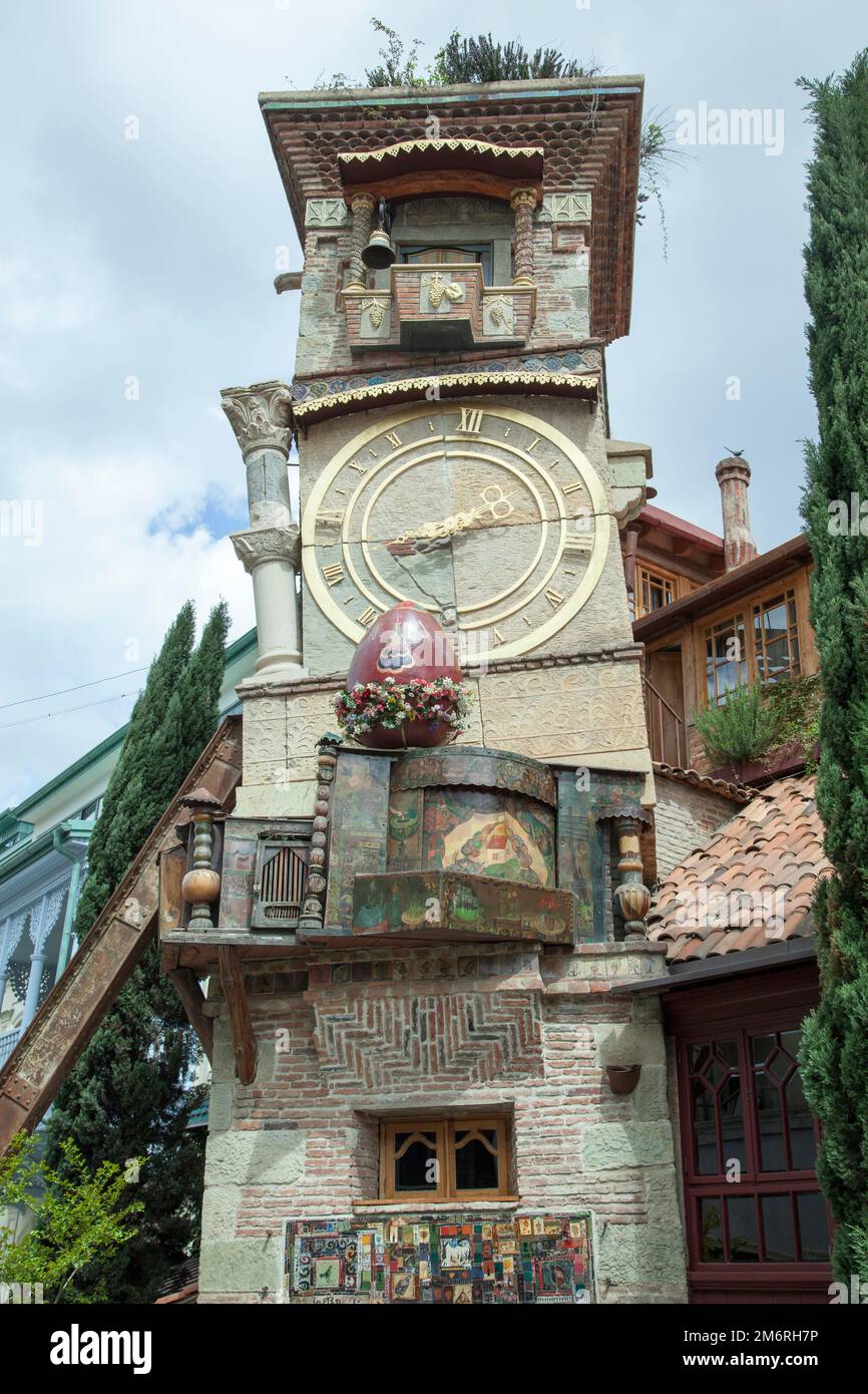 The view of a fairy tale like crooked tower with a clock in Tbilisi old ...