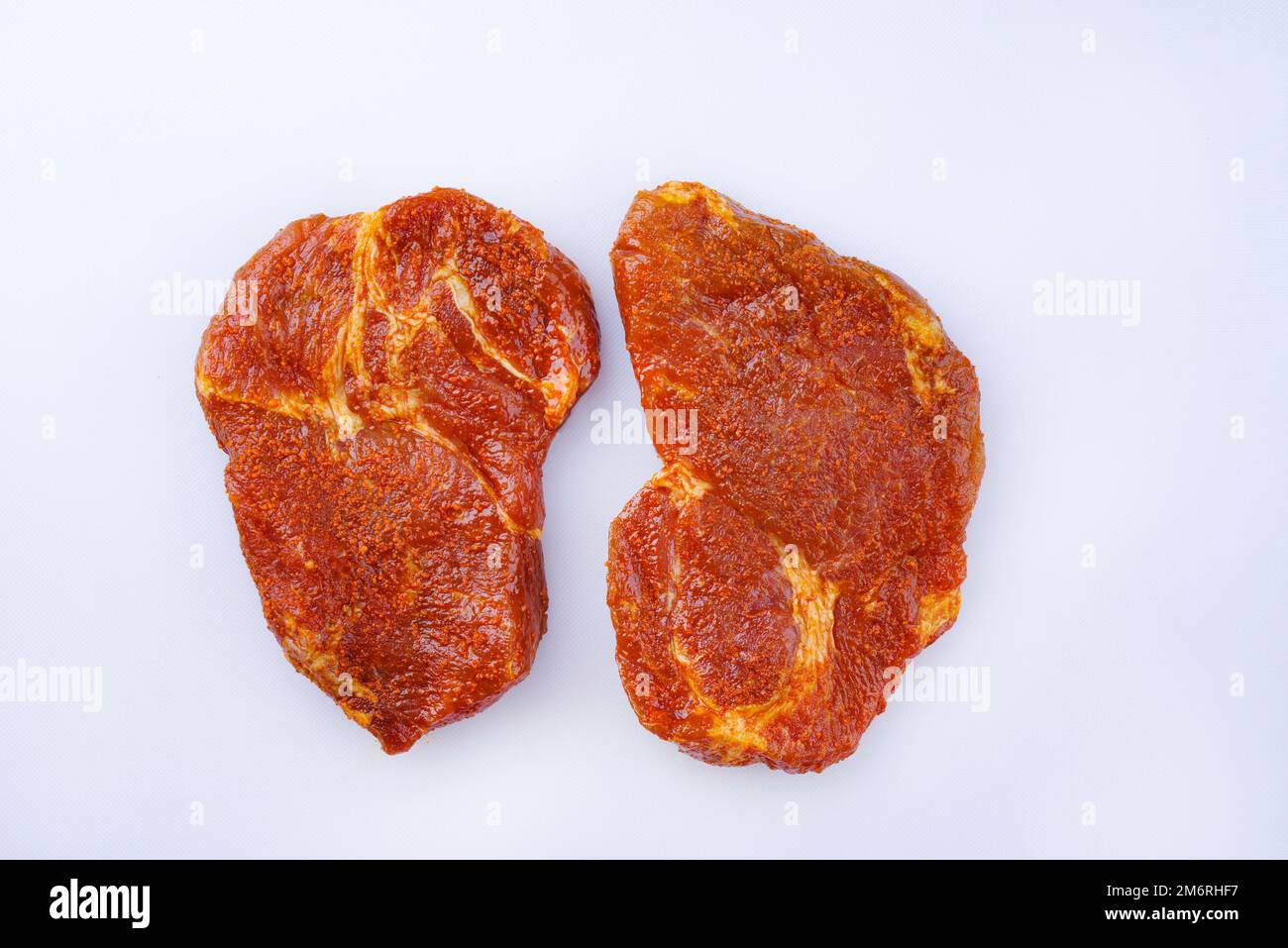 Traditional raw seasoned pork neck steak prepared for a summer barbecue ...