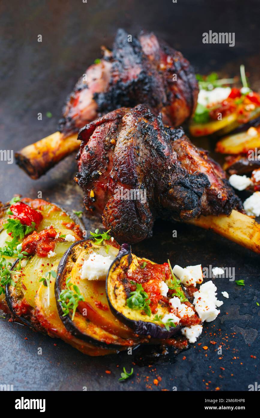 Traditional Greek barbecue lamb shank with vegetable briam served as ...
