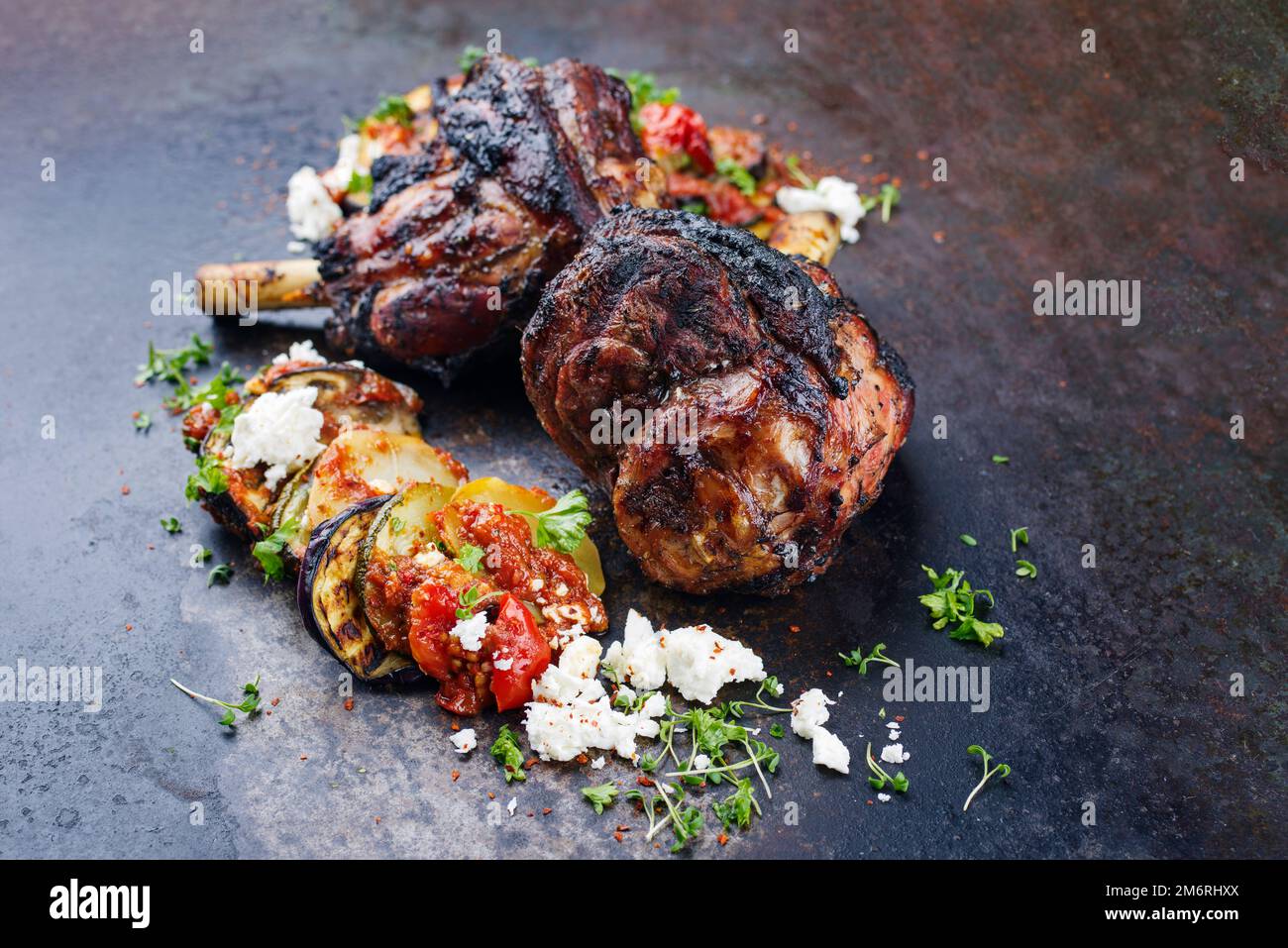 Traditional Greek barbecue lamb shank with vegetable briam served as ...