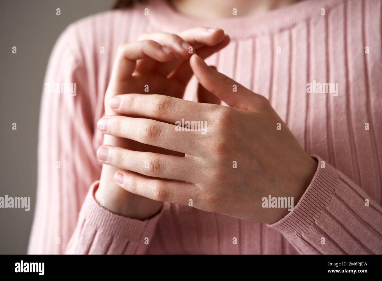 Young teenage girl practicing EFT or emotional freedom technique ...