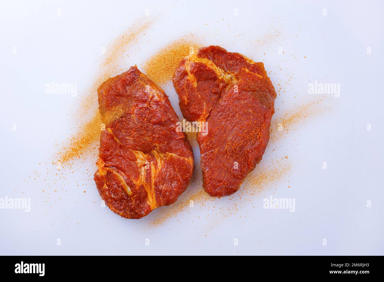 Traditional raw seasoned pork neck steak prepared for a summer barbecue ...