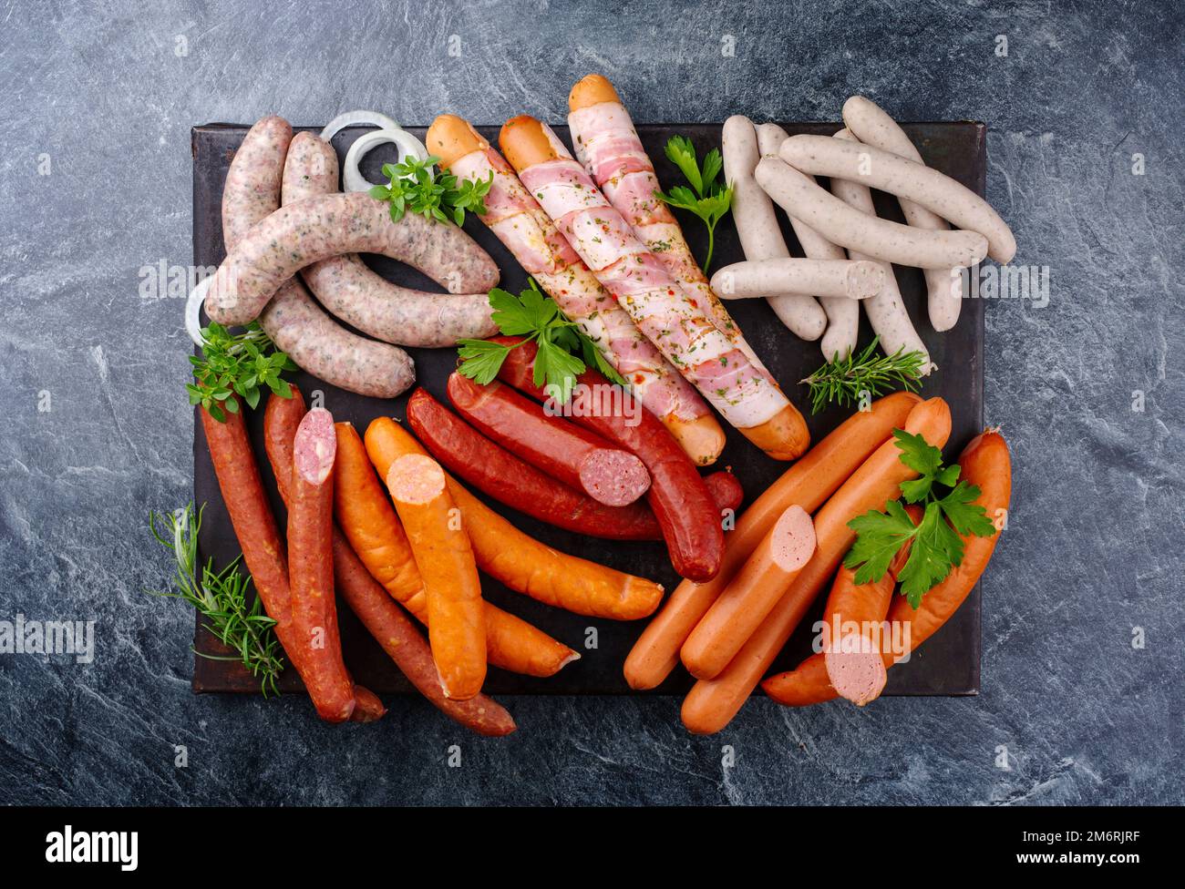 Traditional raw grill platter with different types of bratwursts ...