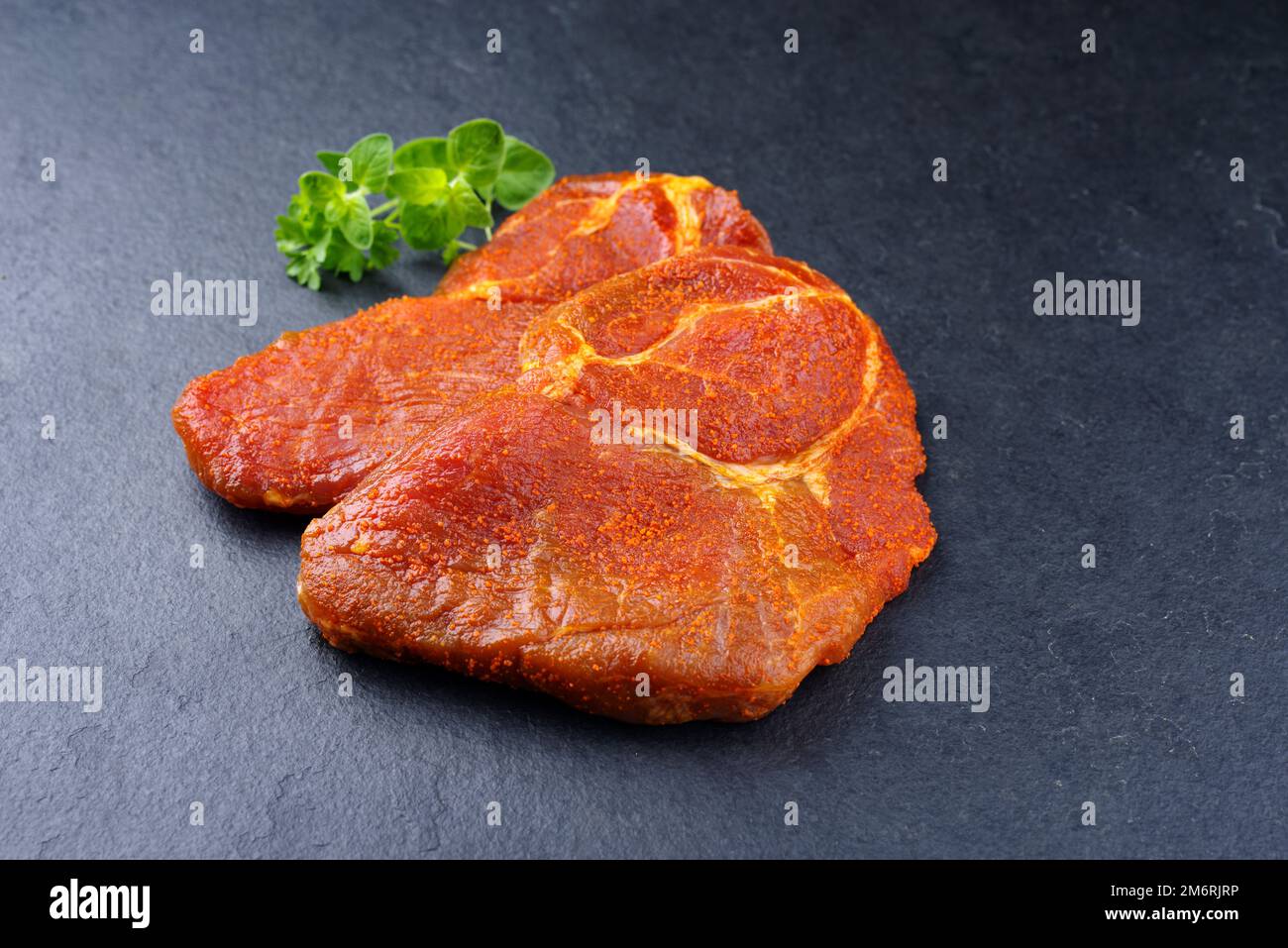 Traditional raw seasoned pork neck steak prepared for a summer barbecue ...