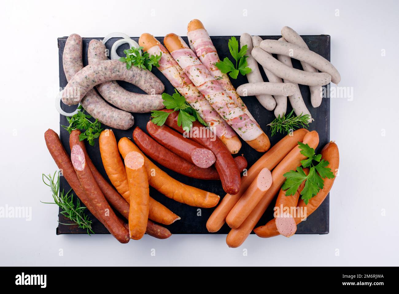 Traditional raw grill platter with different types of bratwursts ...