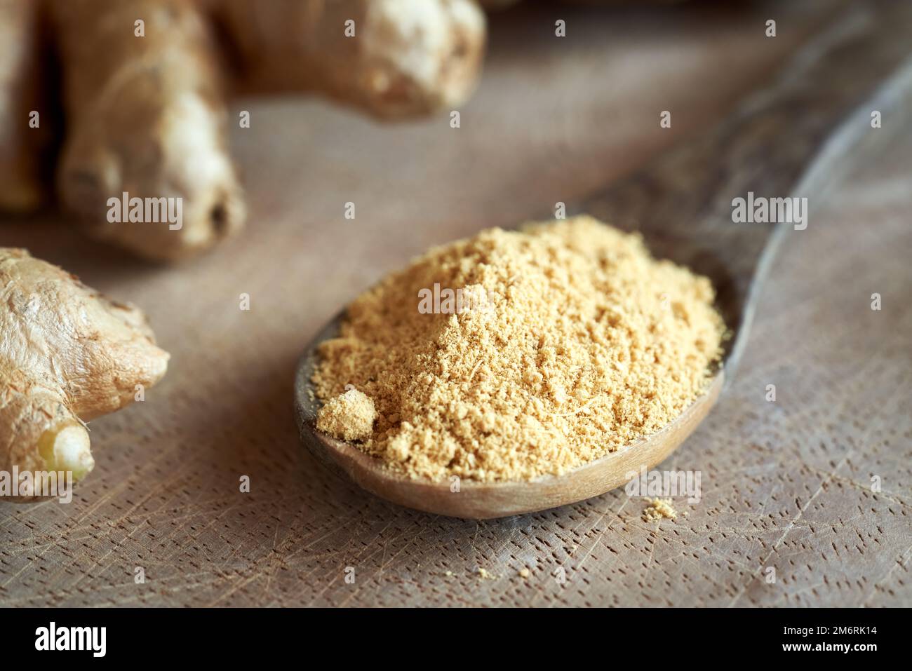 Ground ginger root on a wooden table, close up Stock Photo - Alamy