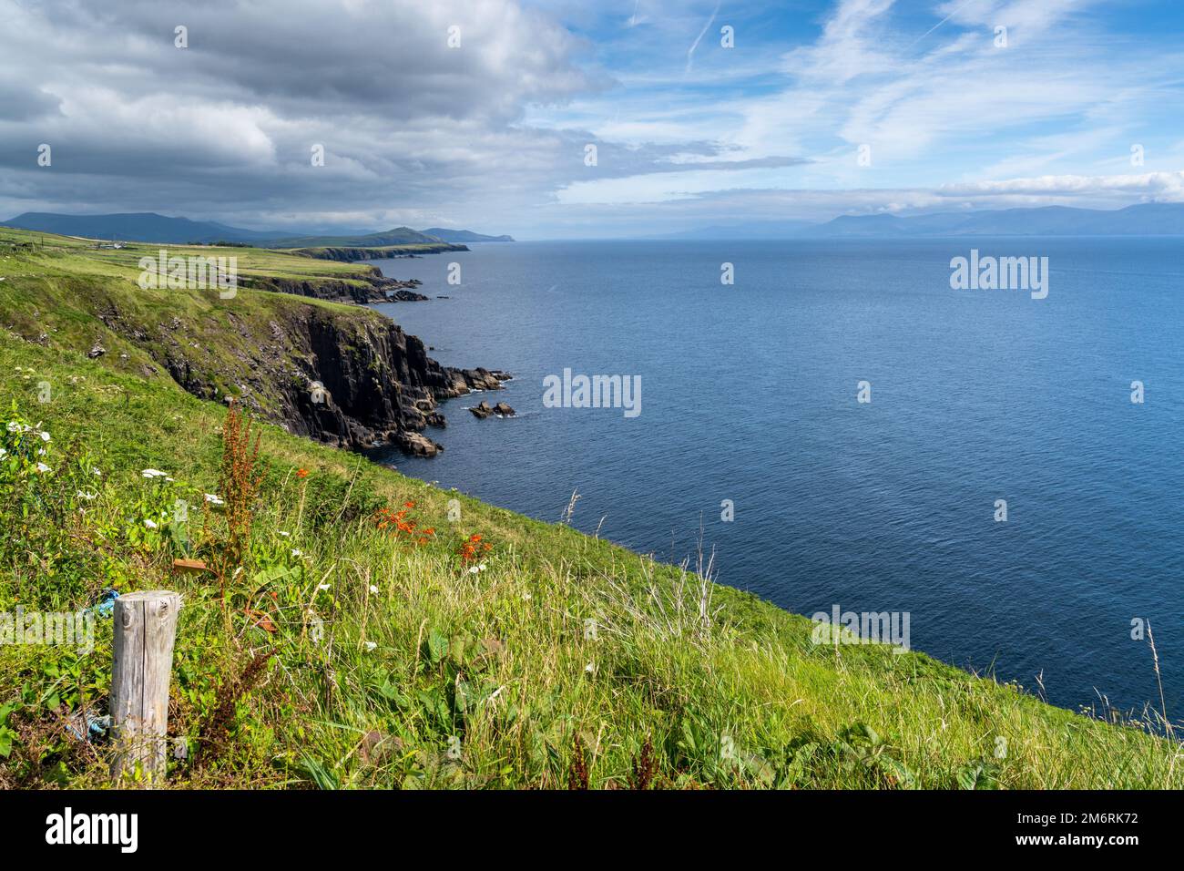 Picturesque coastal landscape with green meadows and rugged cliffs on a ...