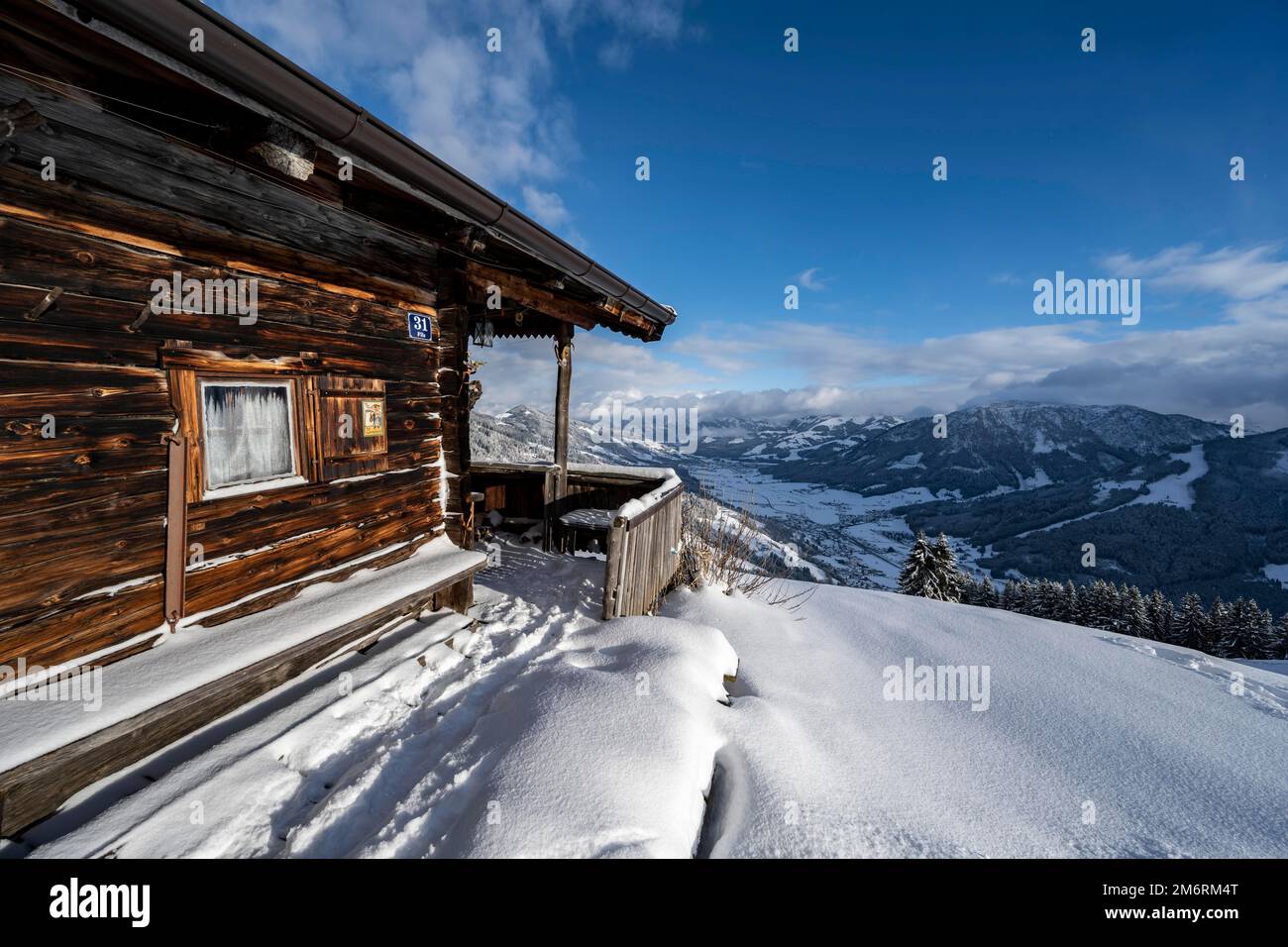 Traditional mountain hut in the snow, at the ski resort Bixen im Thale ...