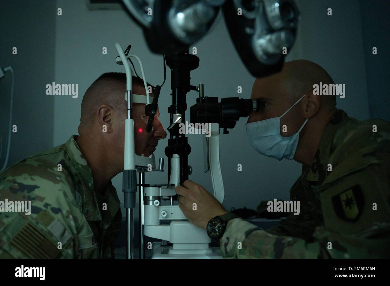U.S. Army Maj. Andrew Bodwell, right, optometrist, Camp Arifjan, looks ...