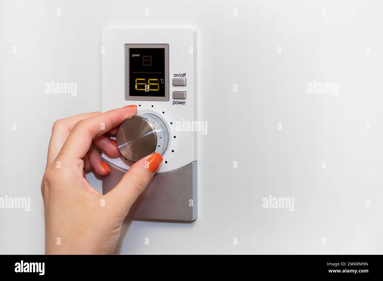 Gas boiler. A woman regulates the temperature with a temperature ...