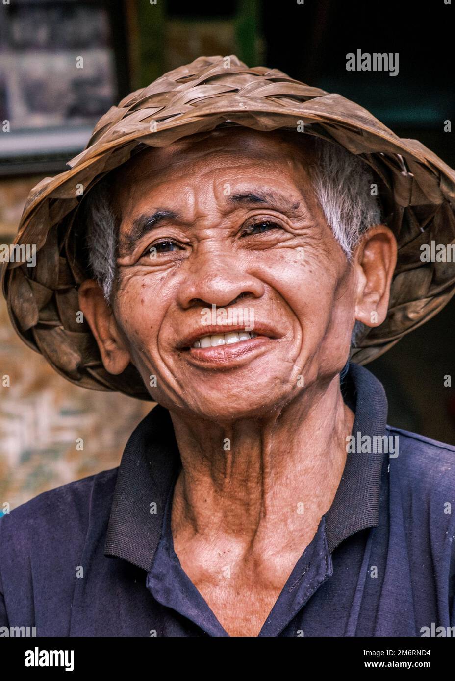 Vertical portrait of South Asian Balinese senior man wearing a ...